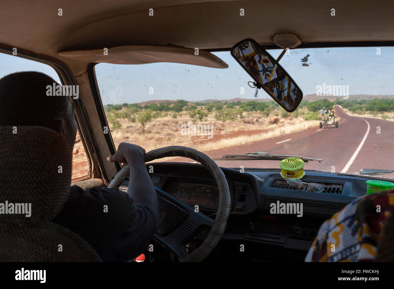 Inside view of African man driving a car on a road in Sahel area Stock ...