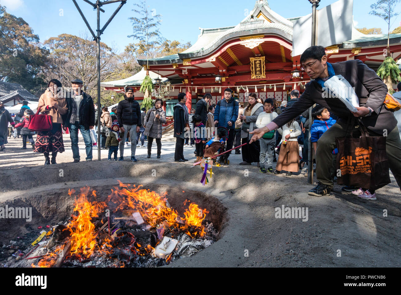 Japanese new year, shogatsu. People praying in front of bonfire used to ...