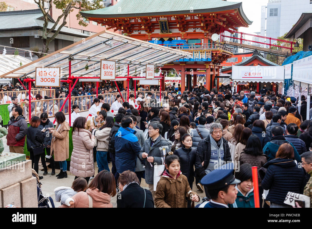 Japanese new year, shogatsu. Shrine Maidens, Miko, at busy counter ...