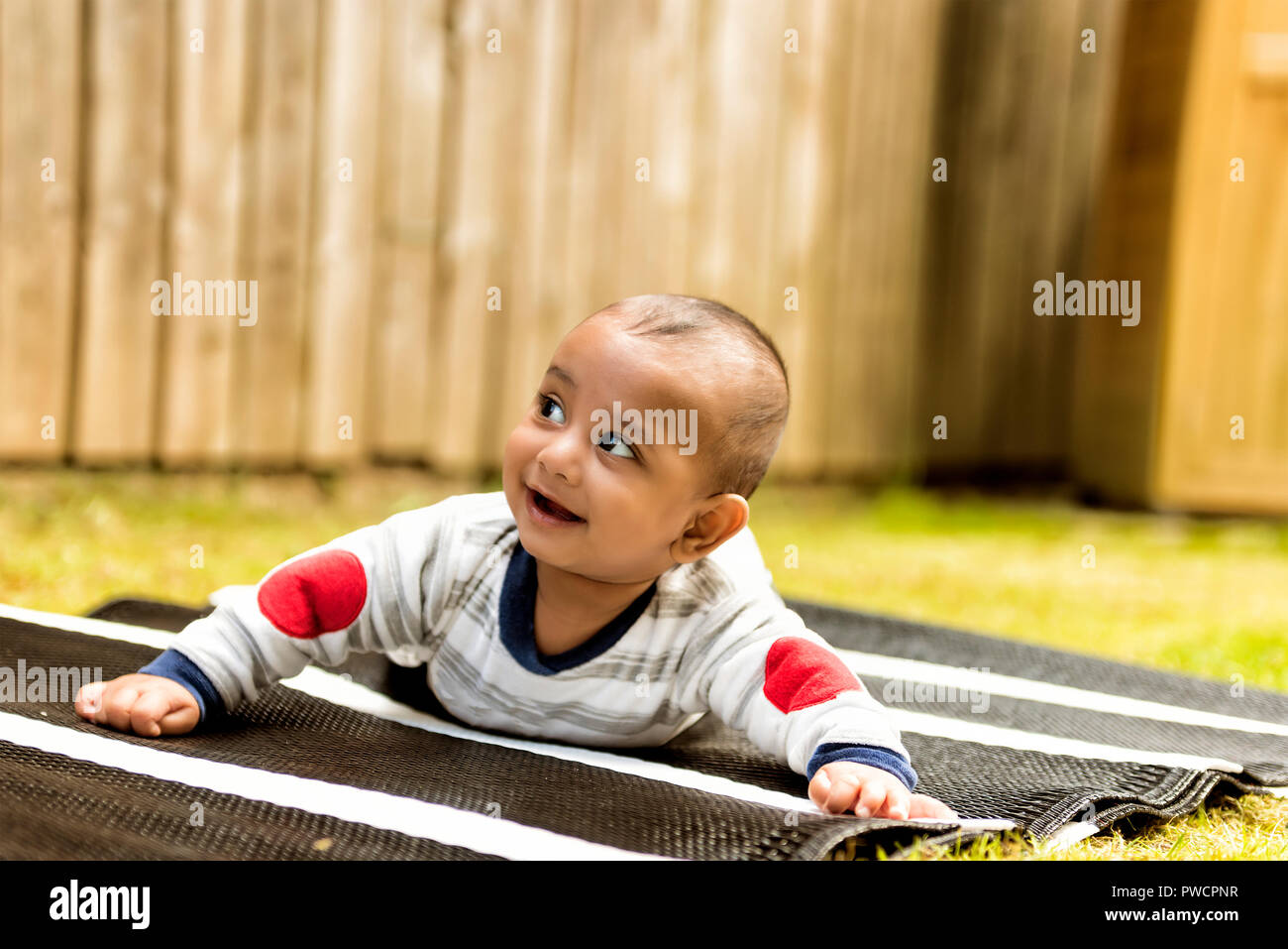 A baby playing outside Stock Photo - Alamy
