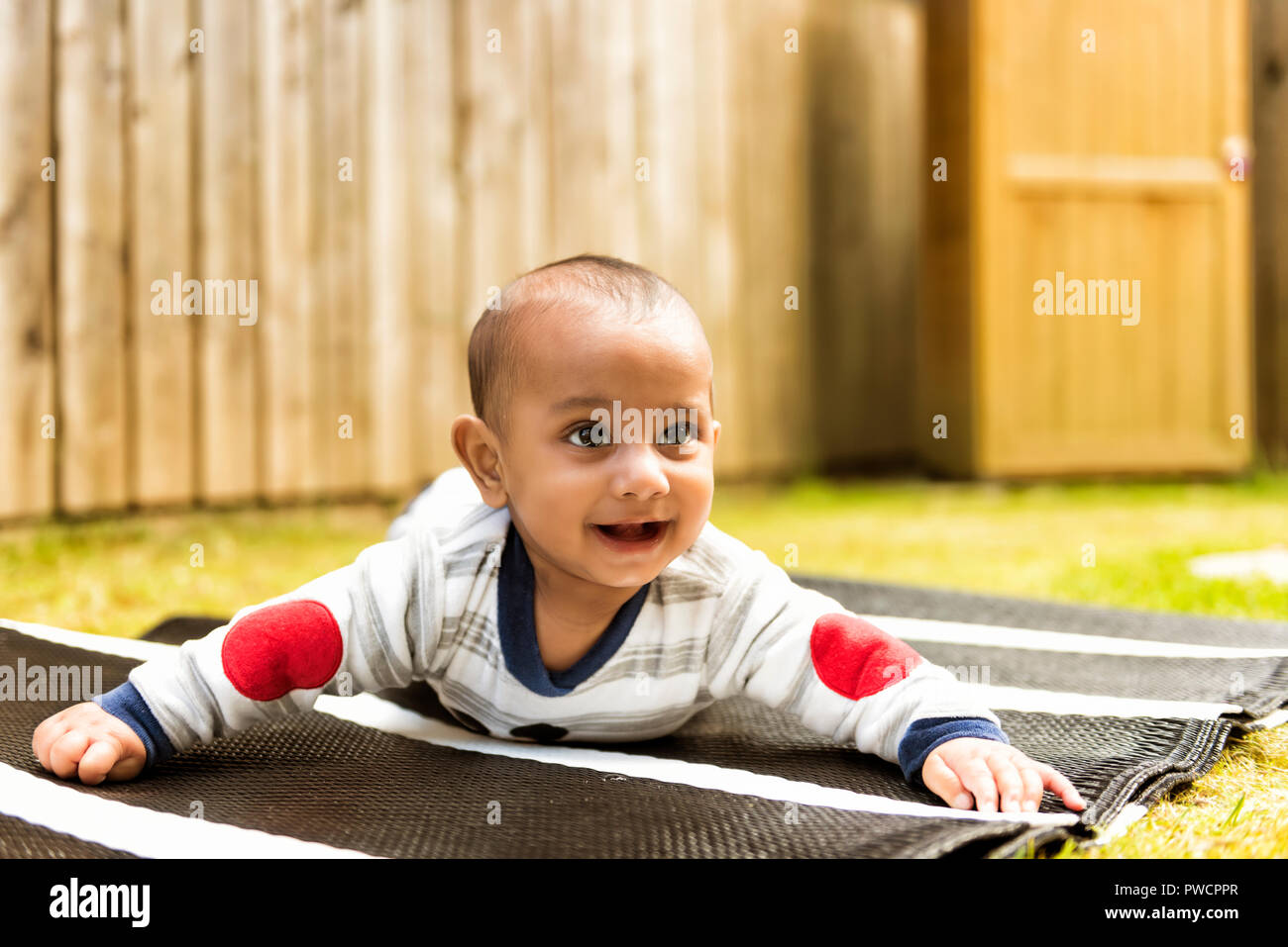 A baby playing outside Stock Photo - Alamy