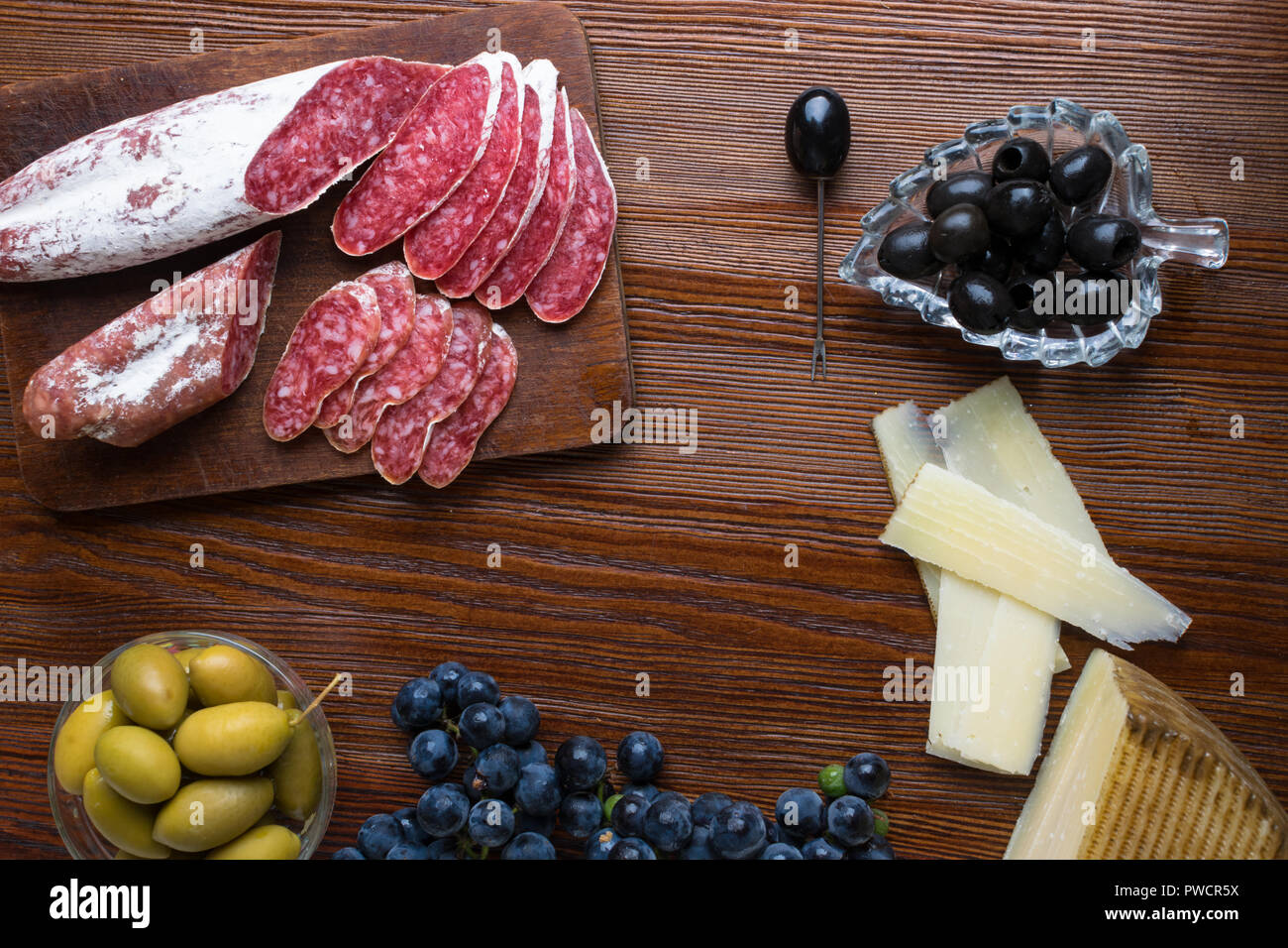 Mix of different snacks and appetizers. Spanish tapas on a wooden plate ...