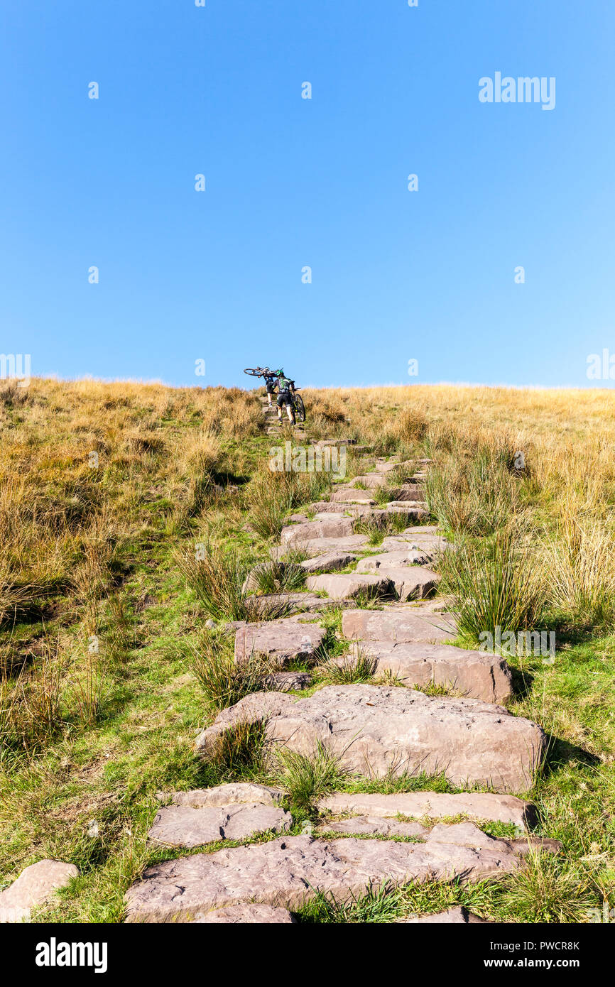 Men carrying bikes up stone path in the Brecon Beacons Stock Photo - Alamy