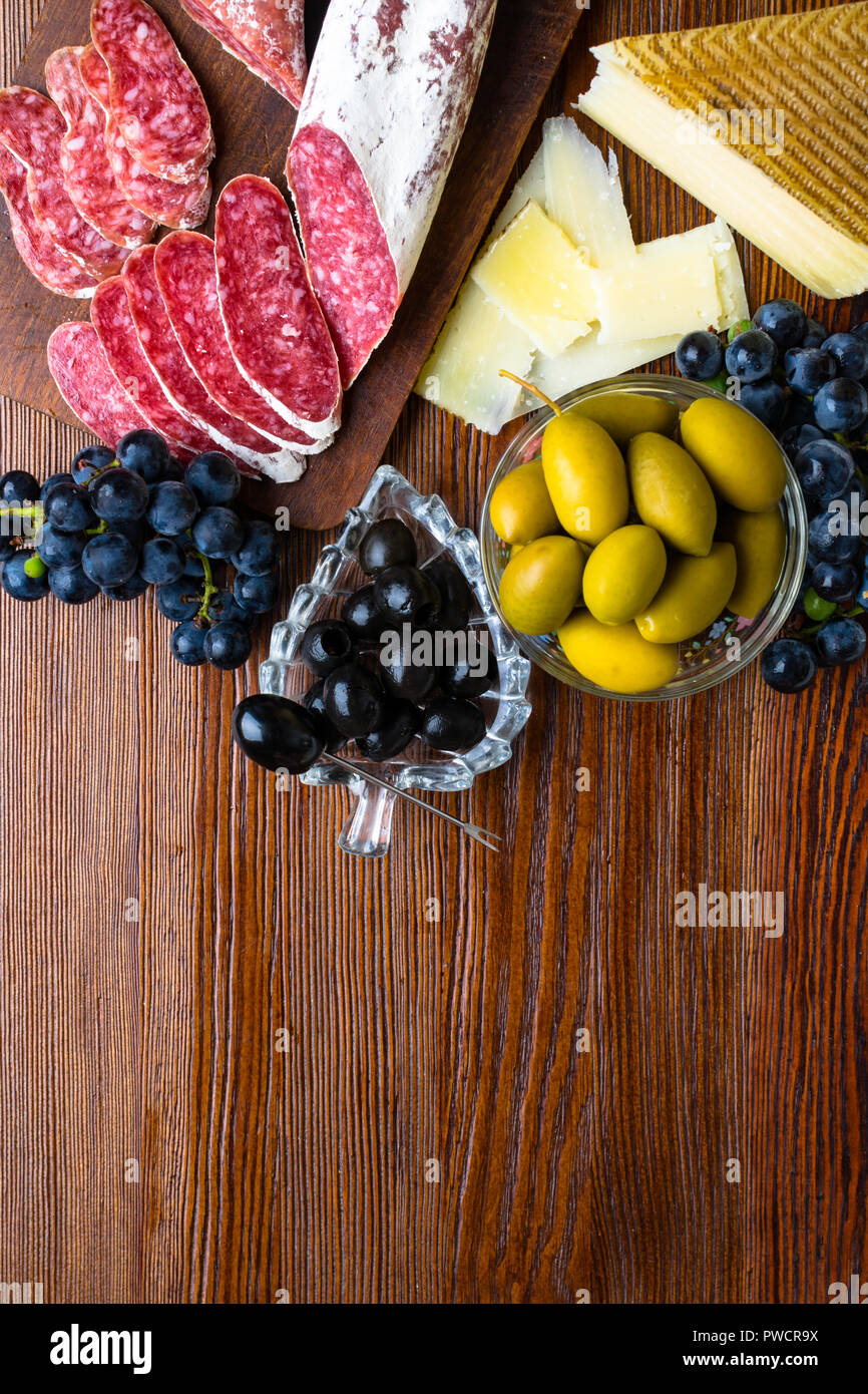 Mix of different snacks and appetizers. Spanish tapas on a wooden plate ...