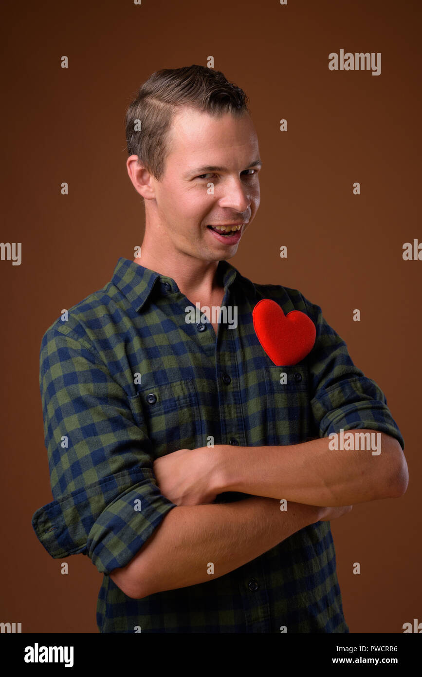 Studio shot of man against brown background Stock Photo - Alamy