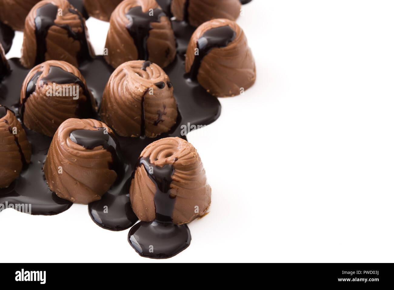 pieces of bonbons covered with melted chocolate isolated on white ...