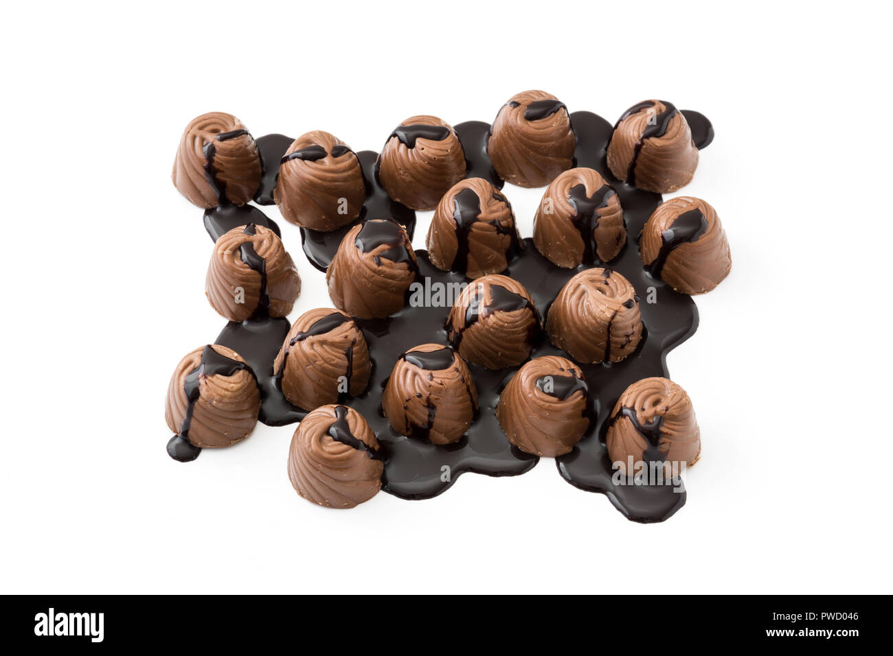 pieces of bonbons covered with melted chocolate isolated on white ...