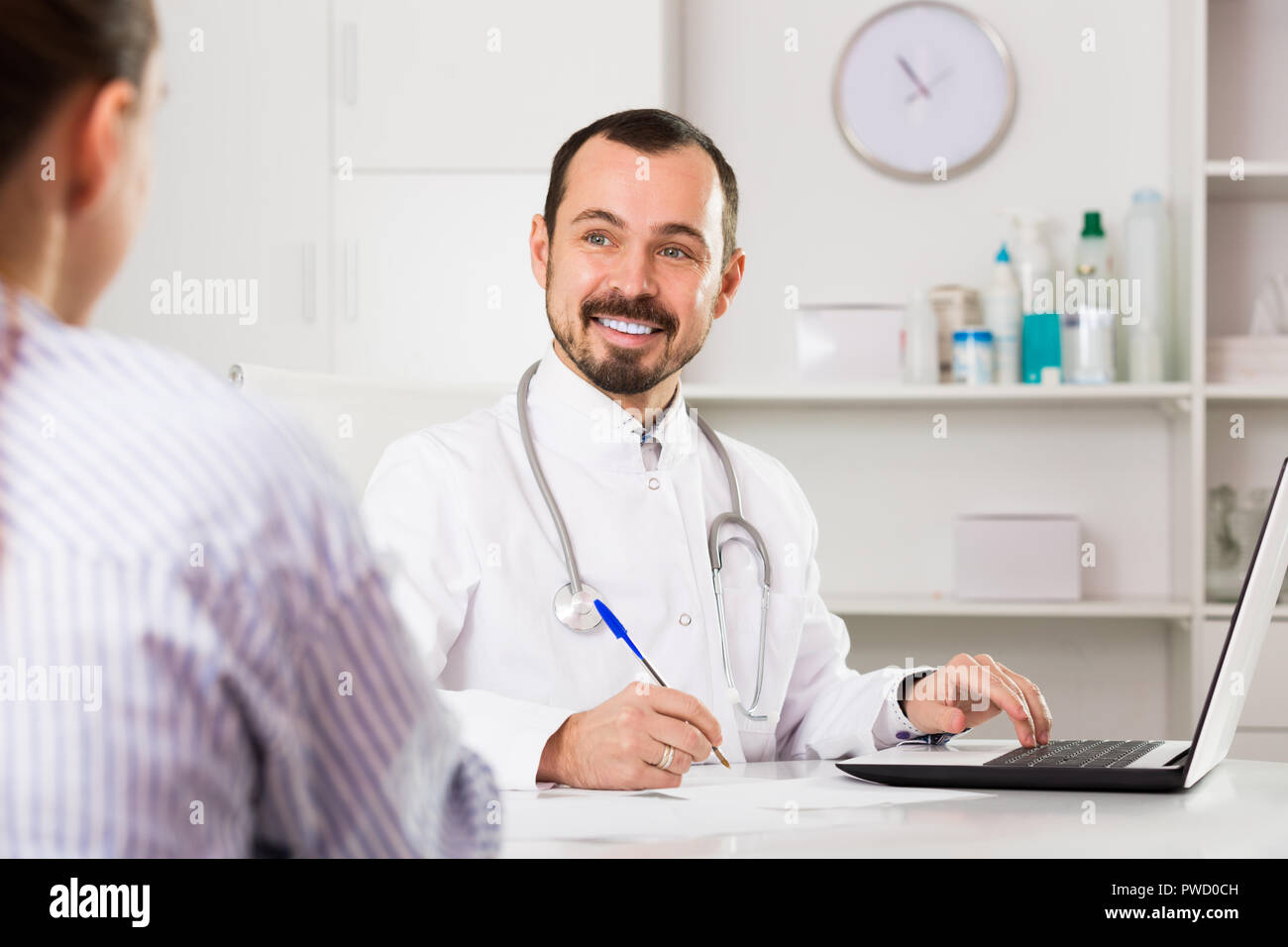 Smiling male doctor consultation client in hospital Stock Photo - Alamy