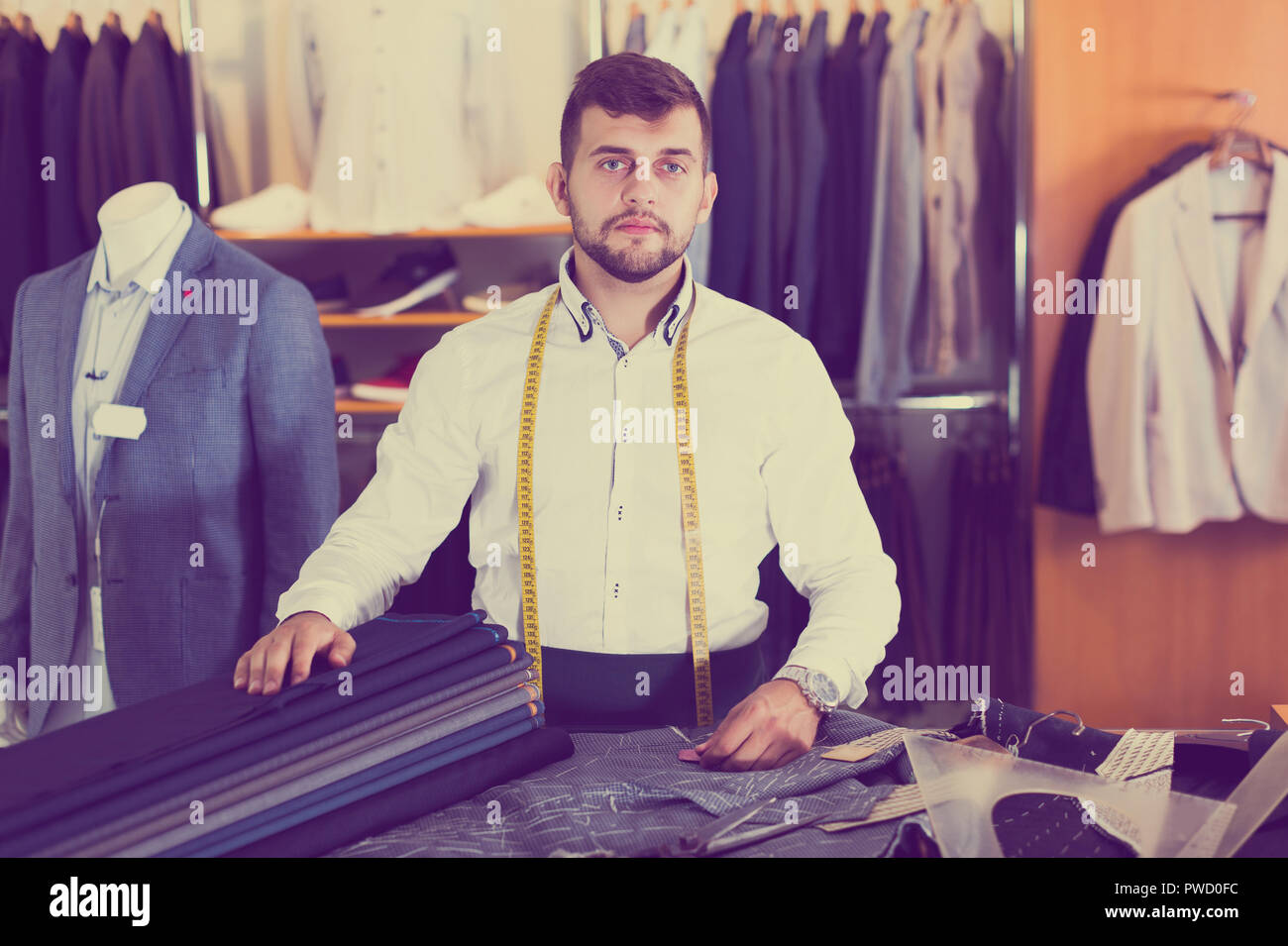 Portrait of positive adult fashioner in workwear in atelier Stock Photo ...