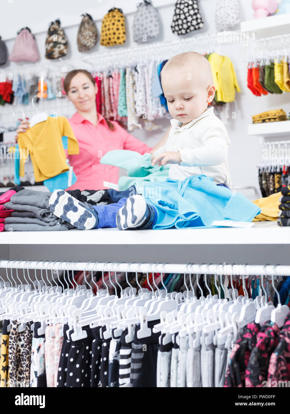 Portrait little kid with his mother who is shopping in kid store Stock ...
