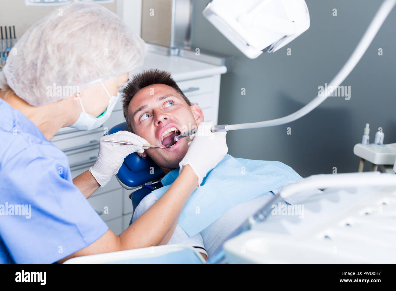Young man visiting dentist, taking care of his health and dental ...