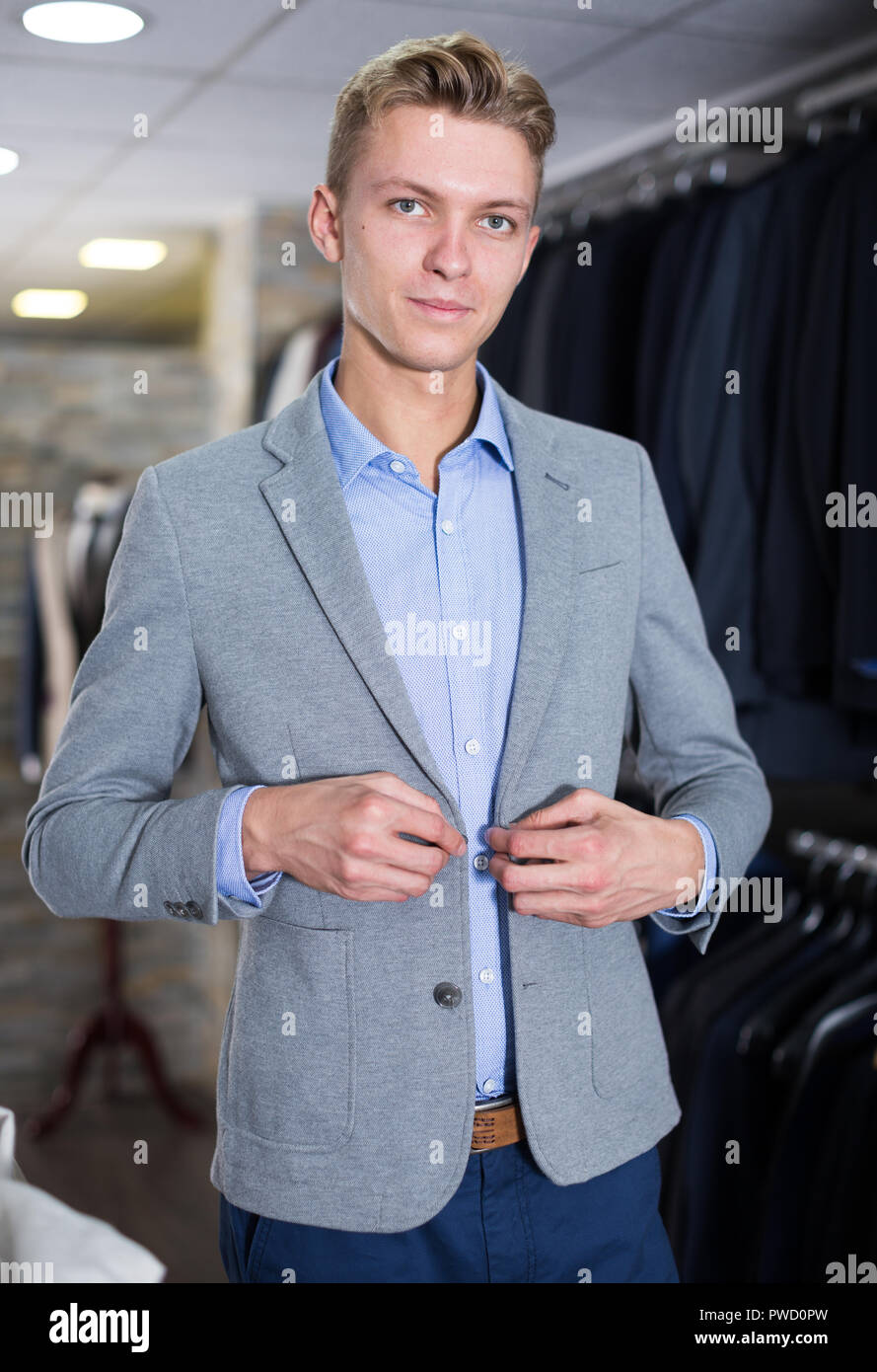 Portrait of man costumer trying business style jacket in the shop Stock ...
