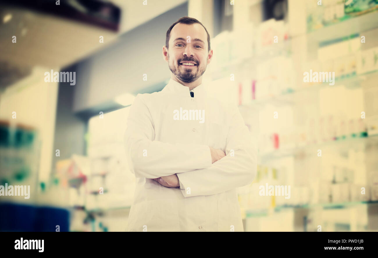 Young man pharmacist displaying assortment of drugs in pharmacy Stock ...
