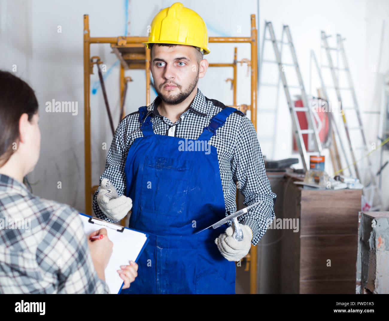 Professional worker with spatula is clarifying details from client at ...