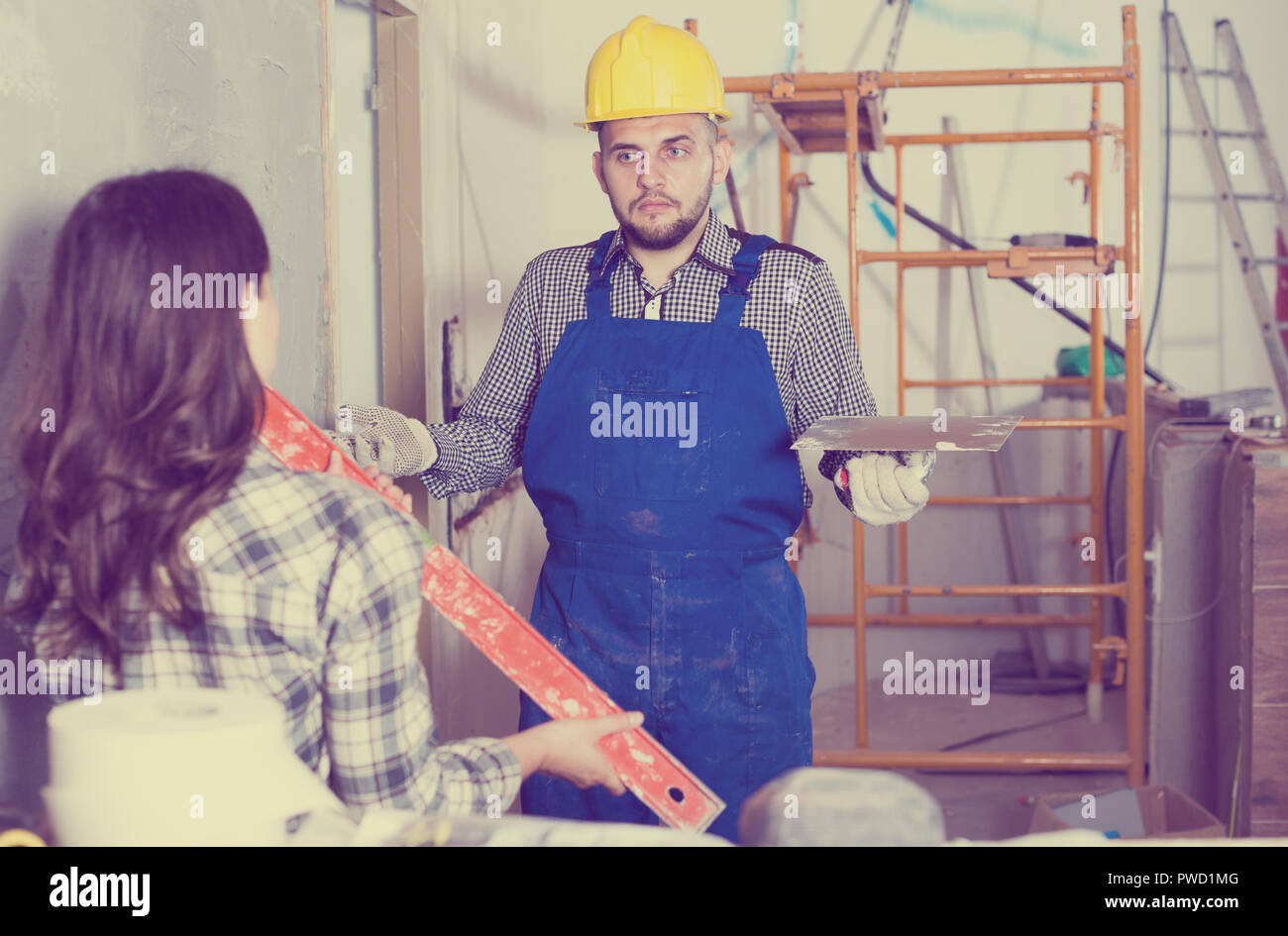 Client woman is checking what worker done at object Stock Photo - Alamy