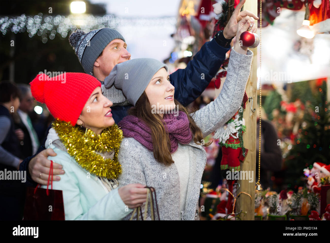 smiling middle-aged married couple with a teenage daughter at Christmas ...