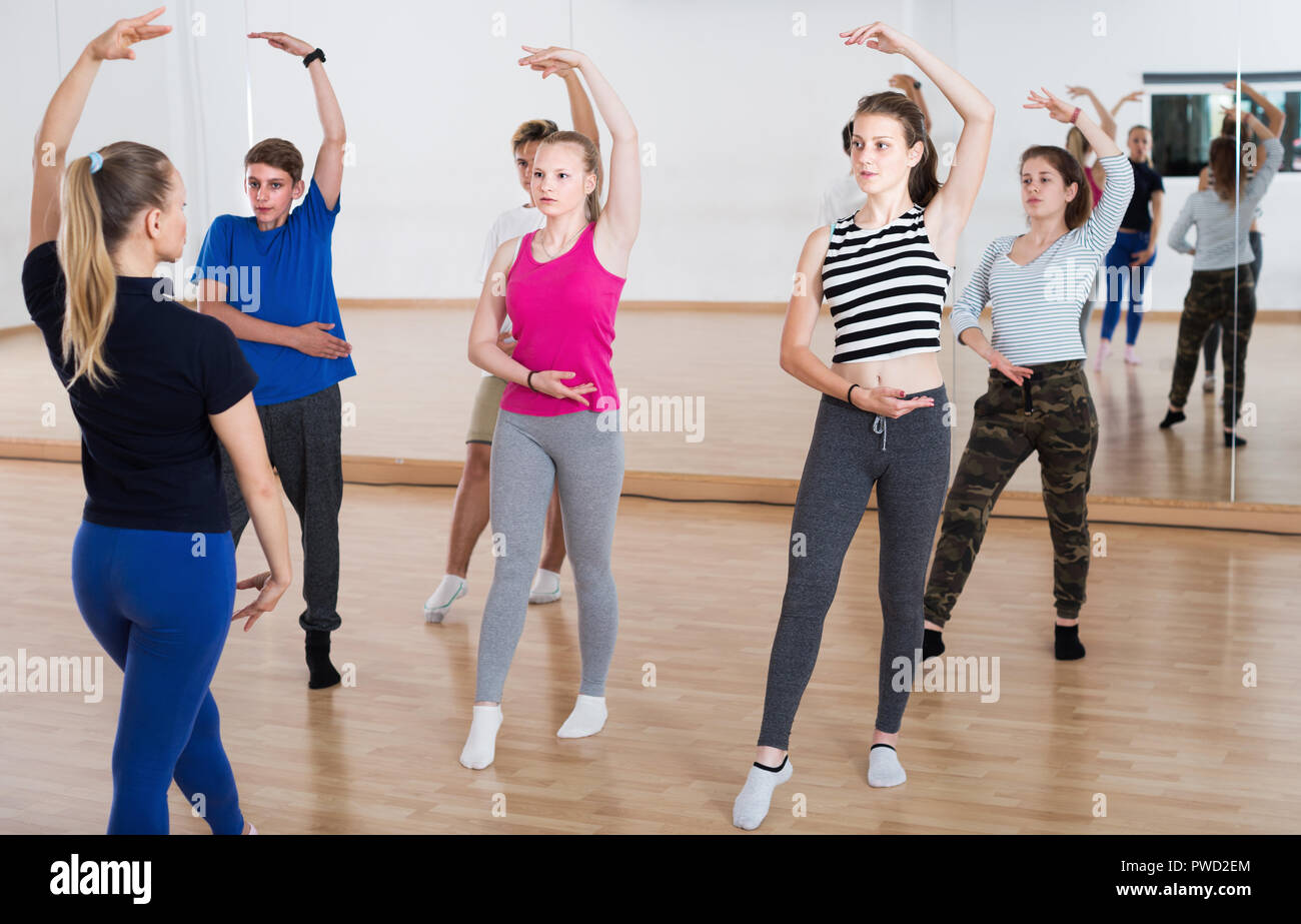 Dance teacher demonstrates the position to teenagers at ballroom Stock ...