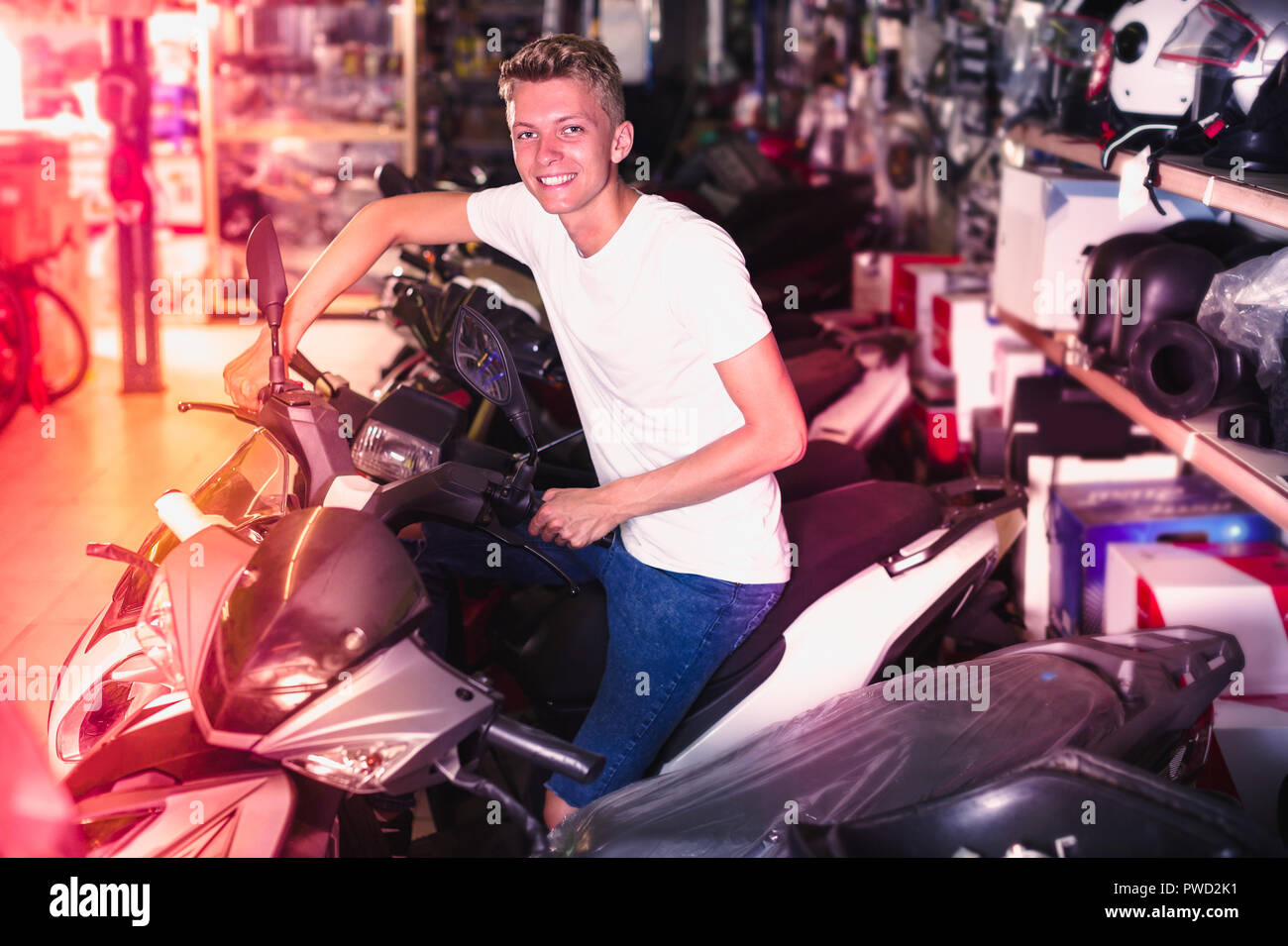 Customer male is sitting on the motorbike in the motorcycle store Stock ...