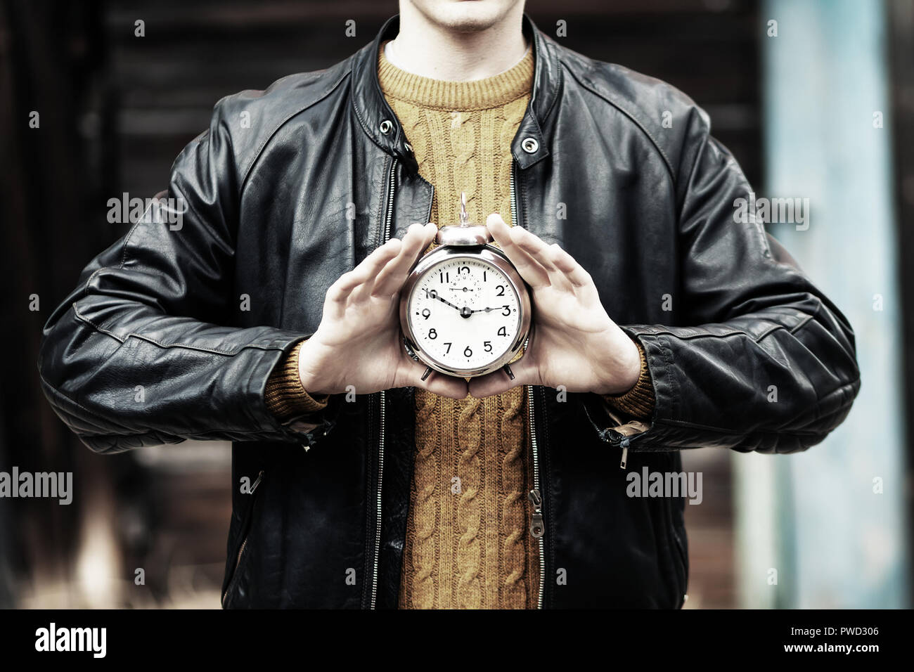 Vintage alarm clock in the hands of man Stock Photo - Alamy