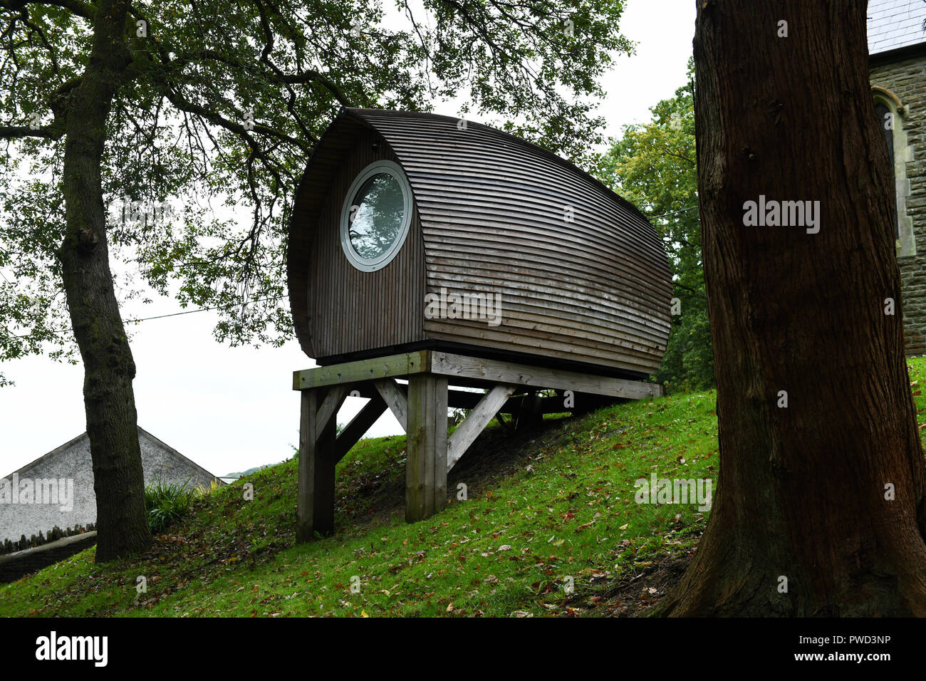 Pictured is a living in wooden pod with a round window Stock Photo - Alamy
