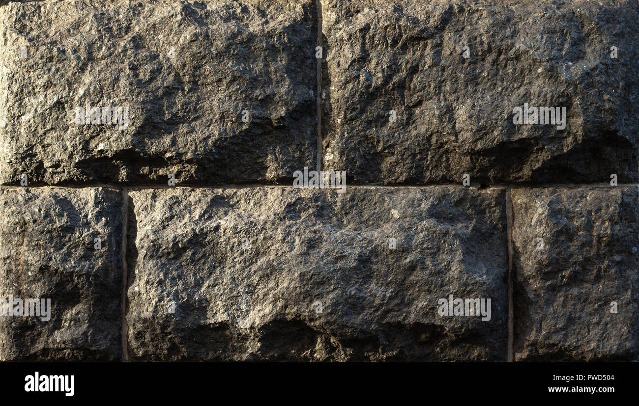 Rough granite texture in sunset sunlight. Natural stone background ...