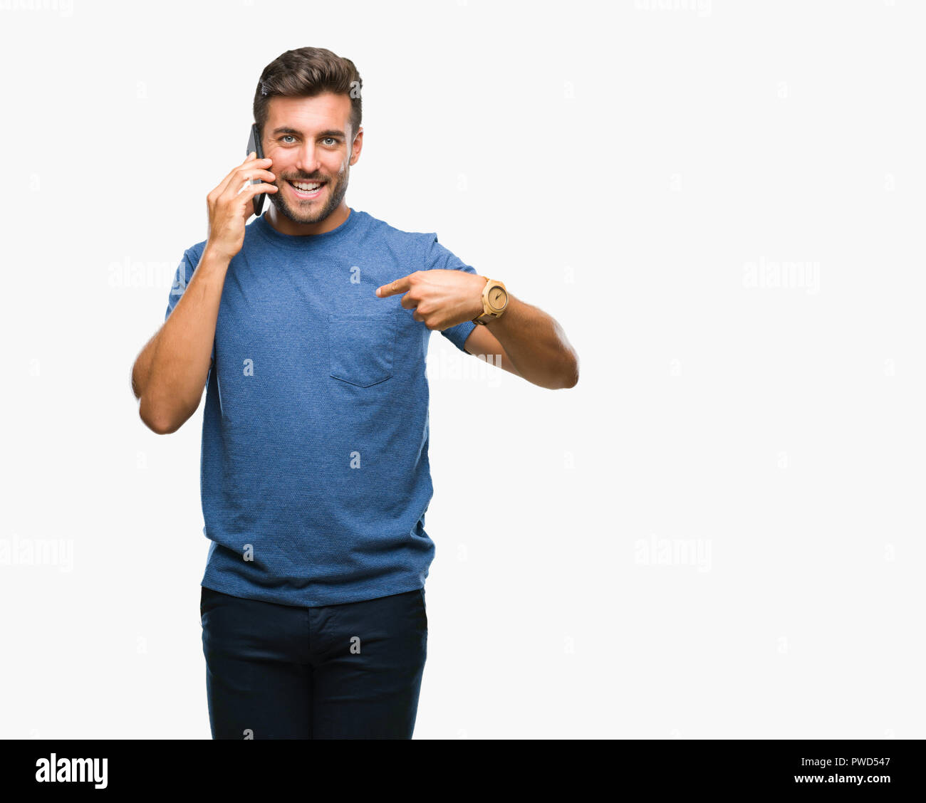 Young handsome man talking on smartphone over isolated background with ...