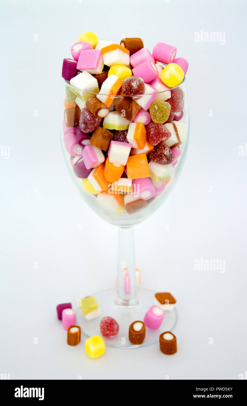 A wine glass of colourful sweets Stock Photo - Alamy