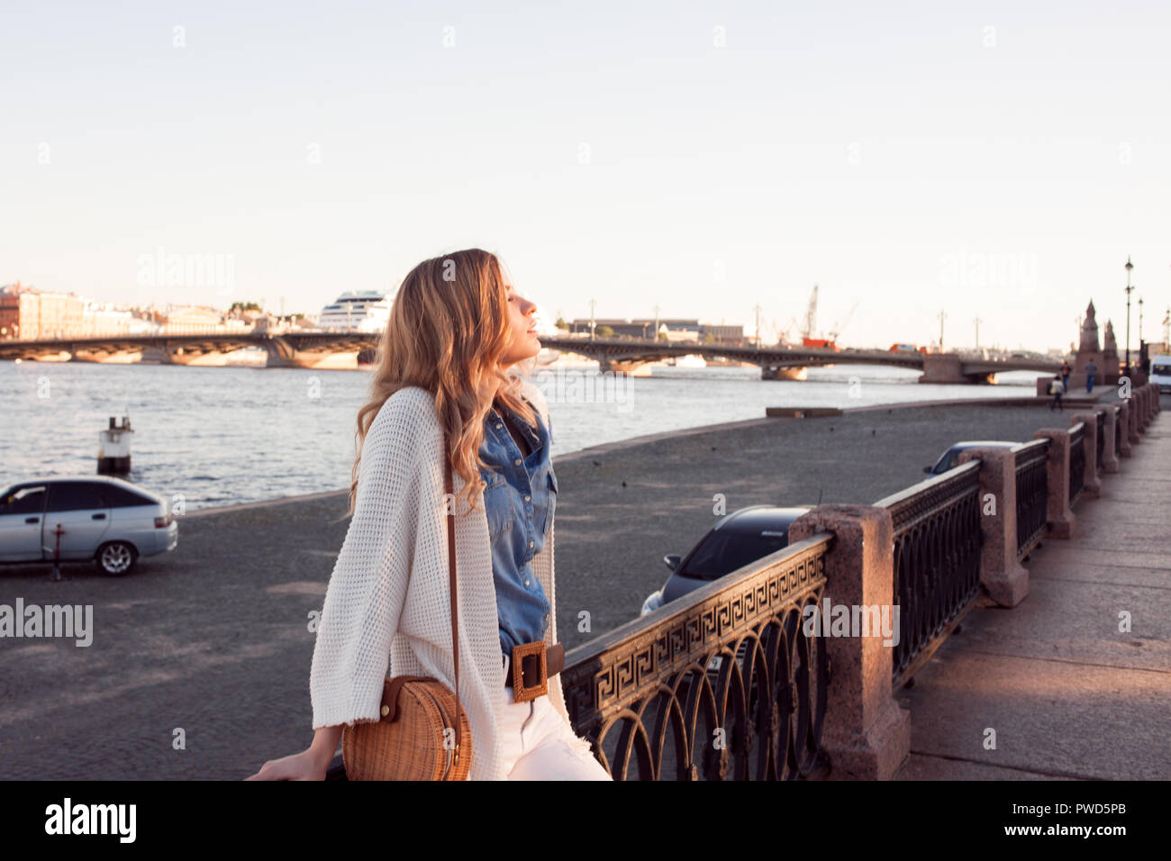 Portrait of smiling woman in a white cardigan. Laughing girl on the ...