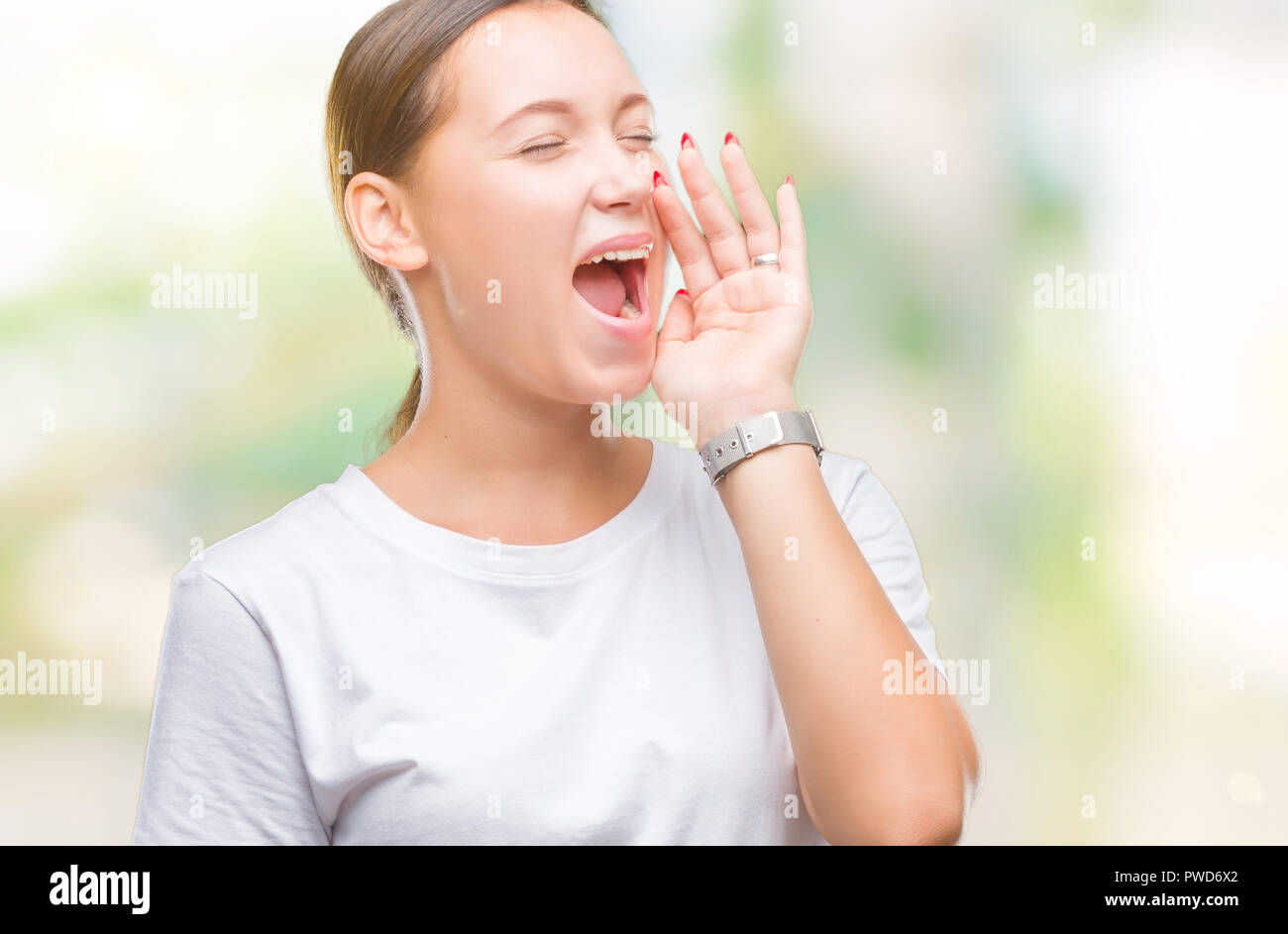 Young beautiful caucasian woman over isolated background shouting and ...