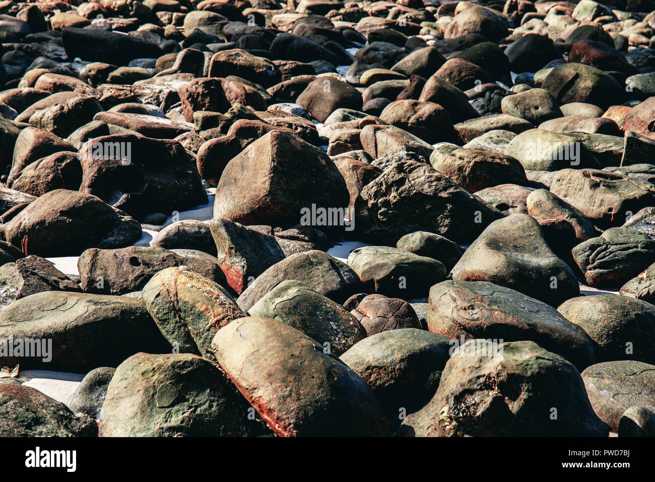 Rocks on shore at the sea with texture background Stock Photo - Alamy