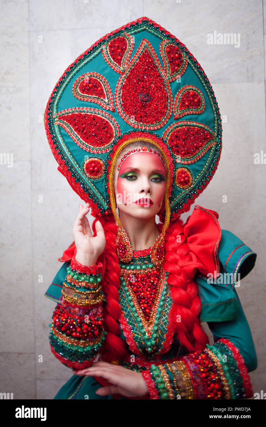 Girl in a headdress. Portrait of a beautiful young woman in a stylized ...