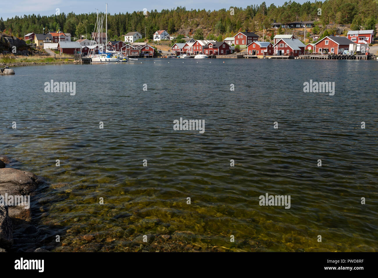 Seashore in foreground and a little fishing village in background ...