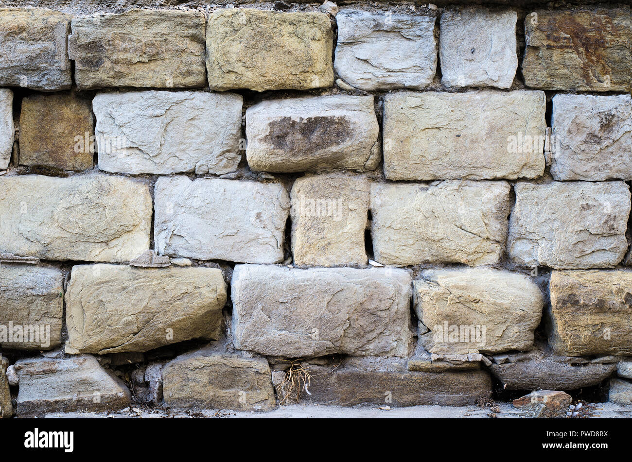 Massive a stone masonry with grey, light brown rectangular rocks ...
