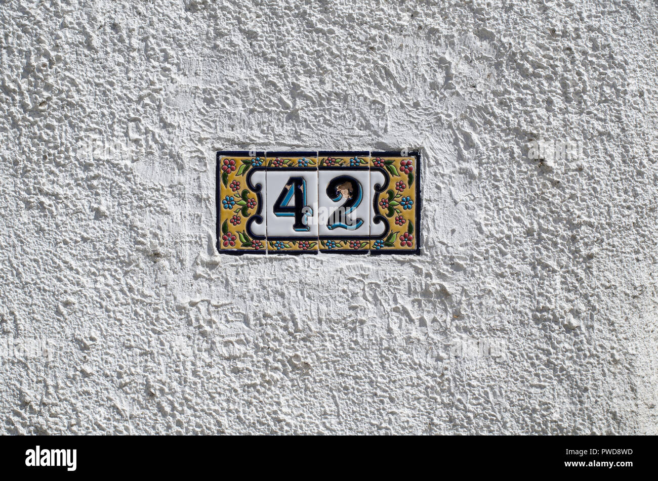 Artistic metal number on the wall near entrance door. It have been draw ...