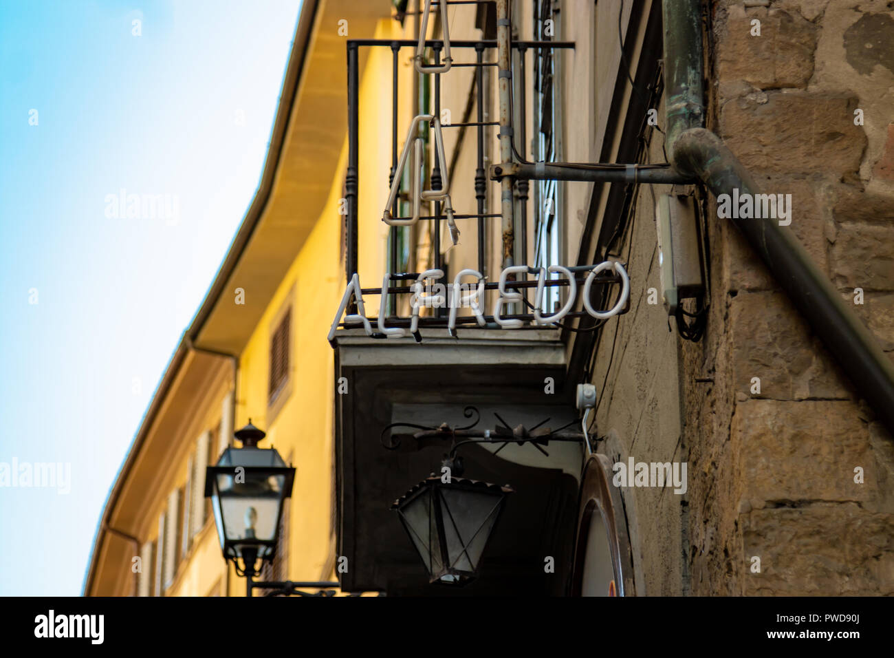 An unlit neon alfredo sign on the side of a building in Florence, Italy ...
