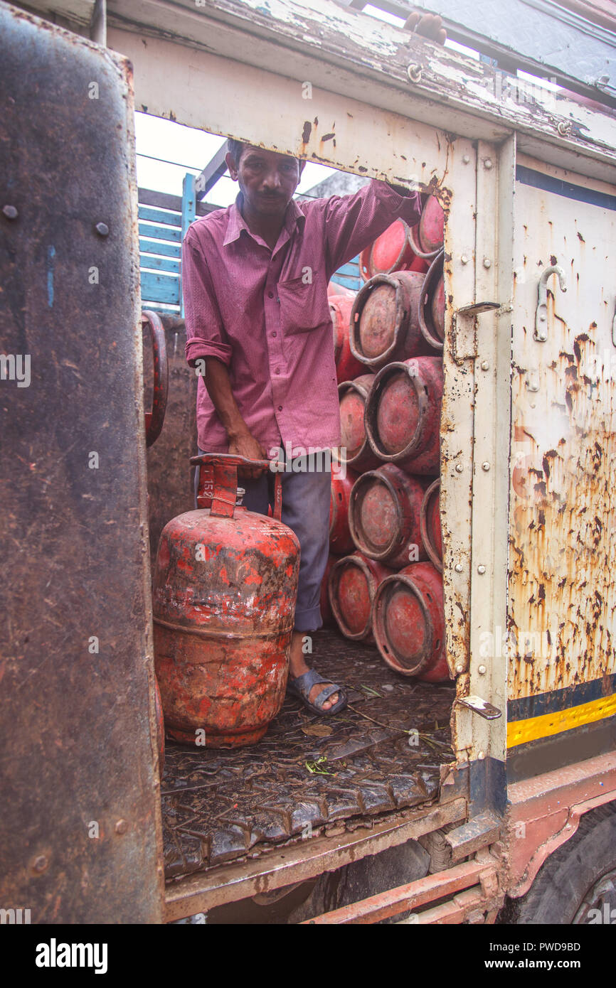 Worker delivering LPG gas cylinders into the truck for customers Stock ...