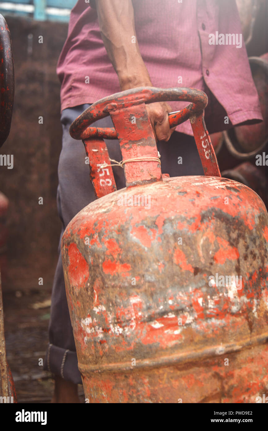 Worker delivering LPG gas cylinders into the truck for customers Stock ...