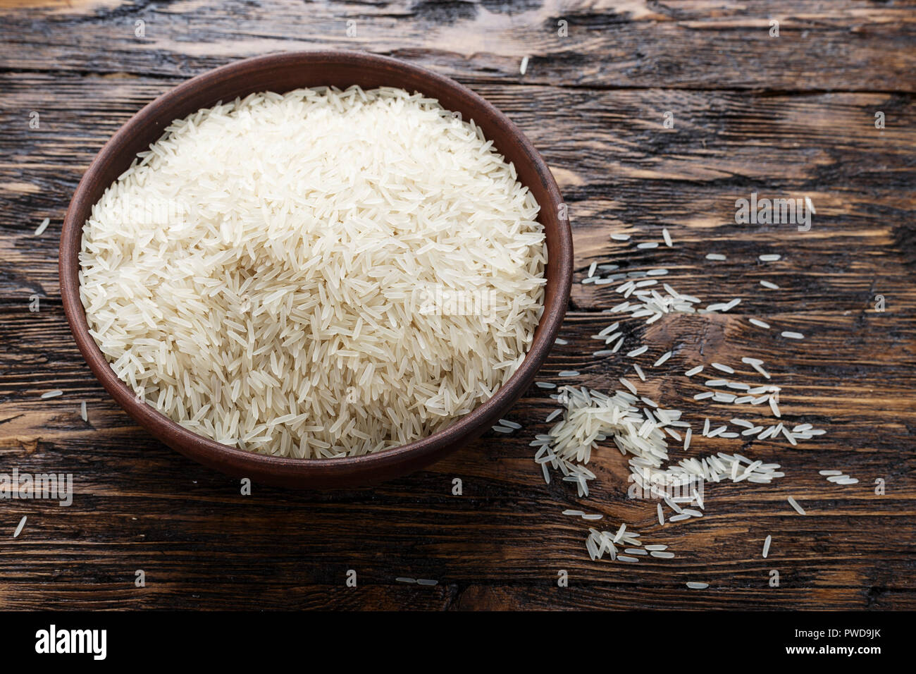raw long rice in a plate on a wooden table. place for text Stock Photo ...