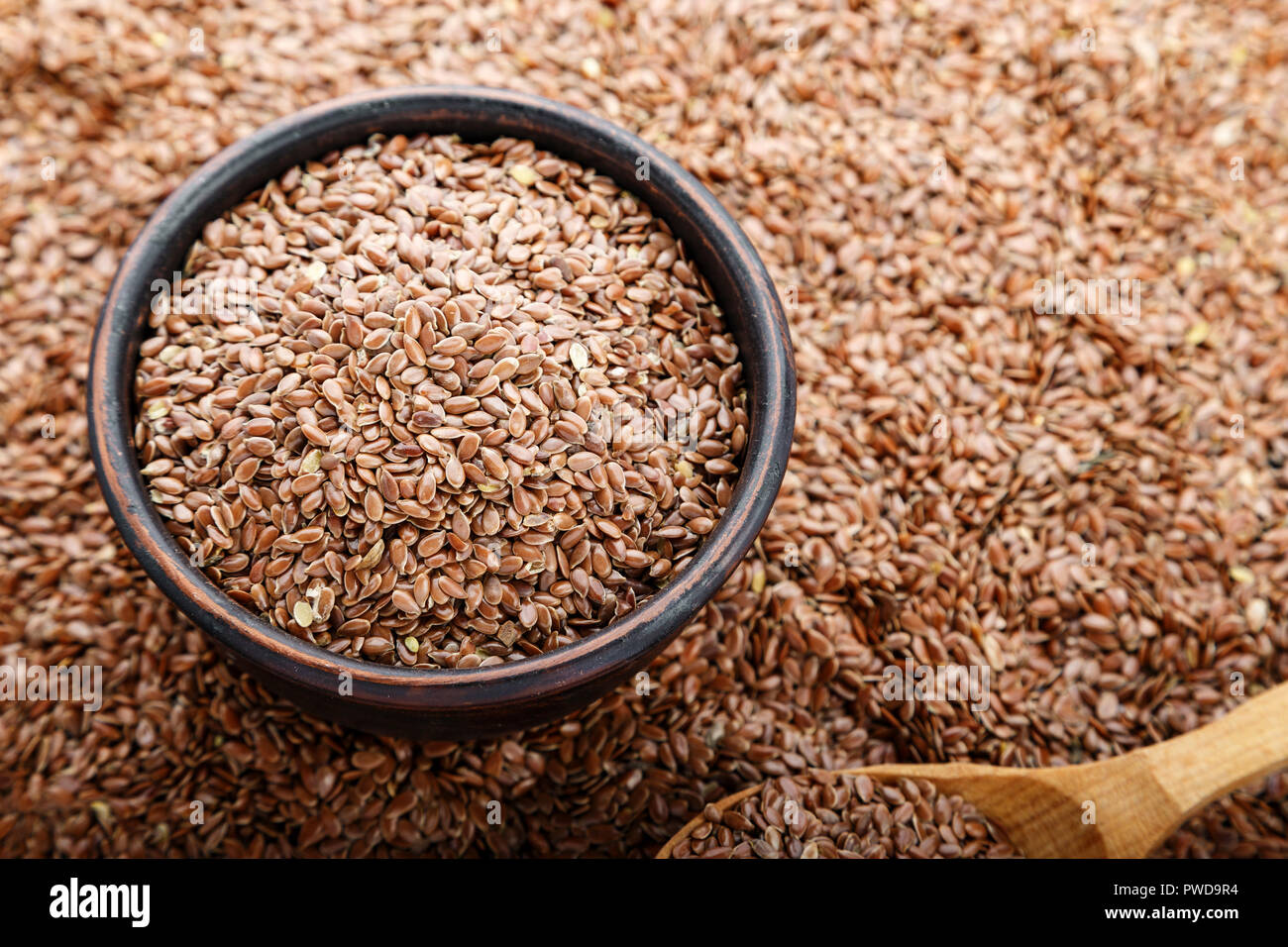 flax seeds are scattered as a background. on seeds worth plate and spoon Stock Photo - Alamy