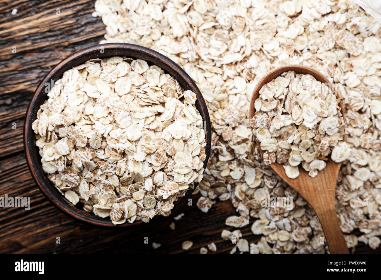 raw oatmeal scattered as a background. cooking oatmeal breakfast Stock ...