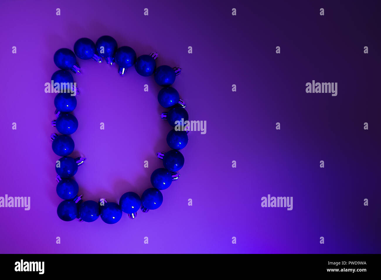 Christmas alphabet of blue neon Christmas balls on a gradient lilac ...