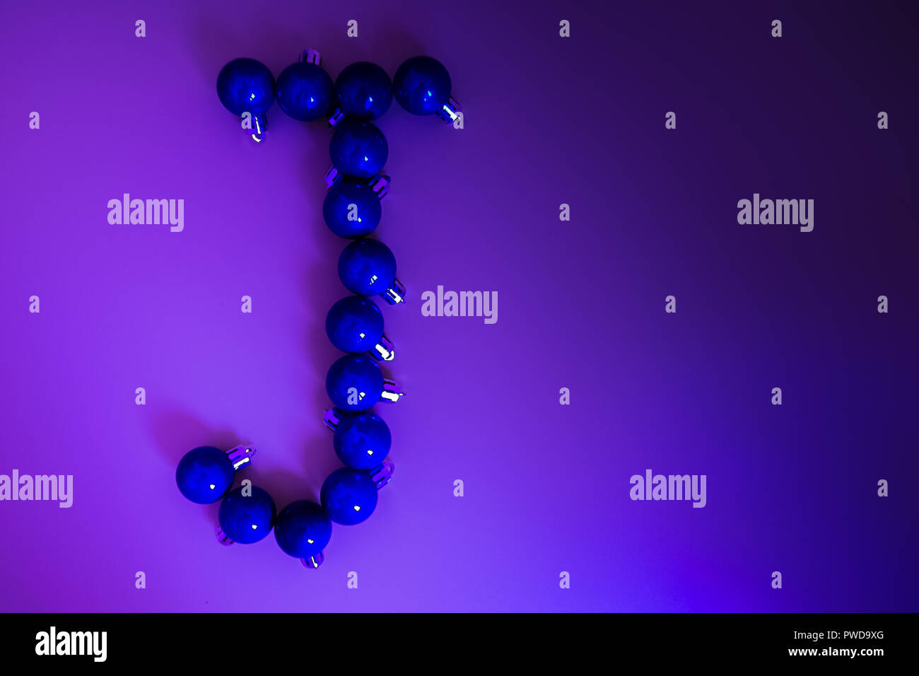 Christmas alphabet of blue neon Christmas balls on a gradient lilac ...