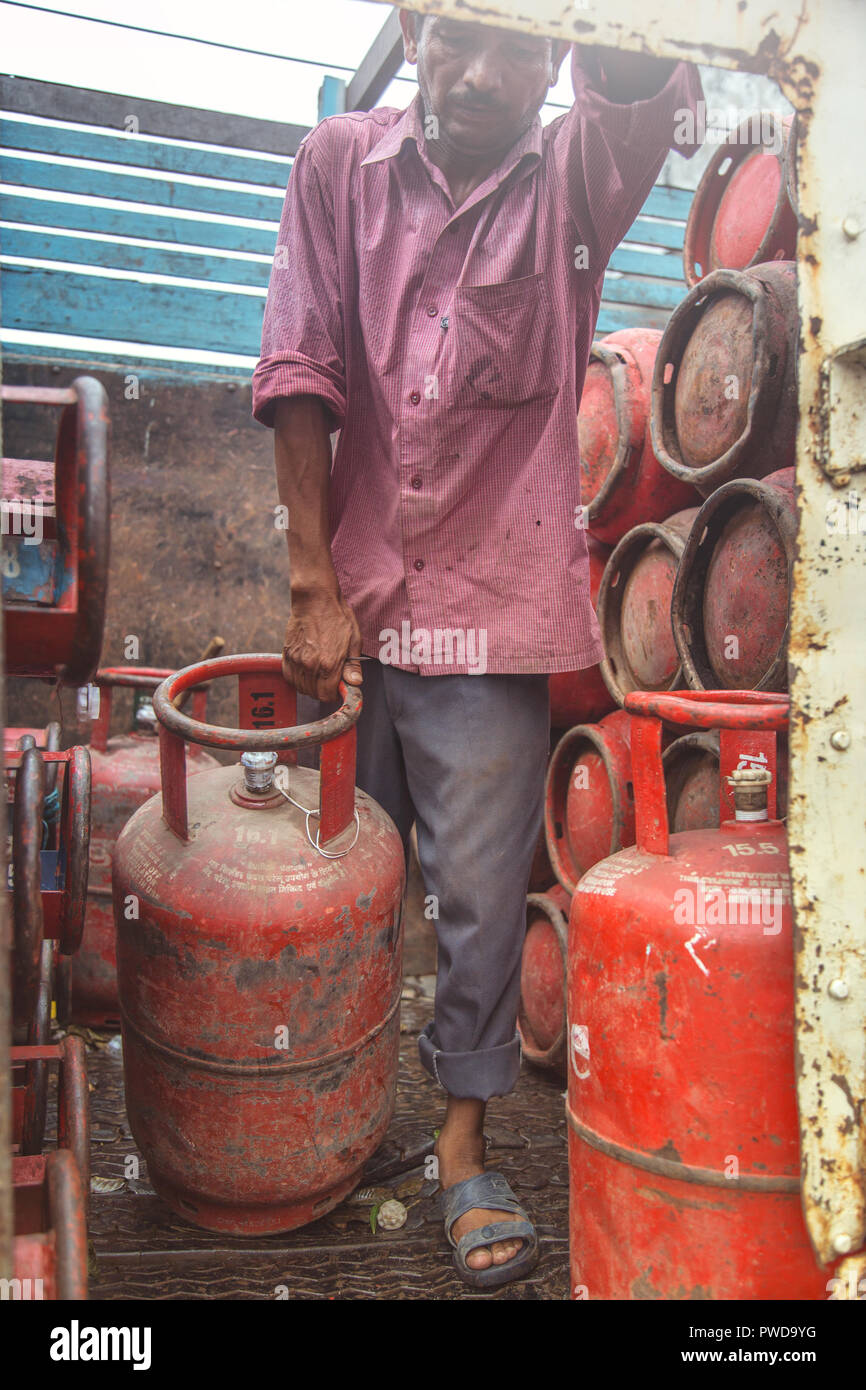 Worker delivering LPG gas cylinders into the truck for customers Stock ...