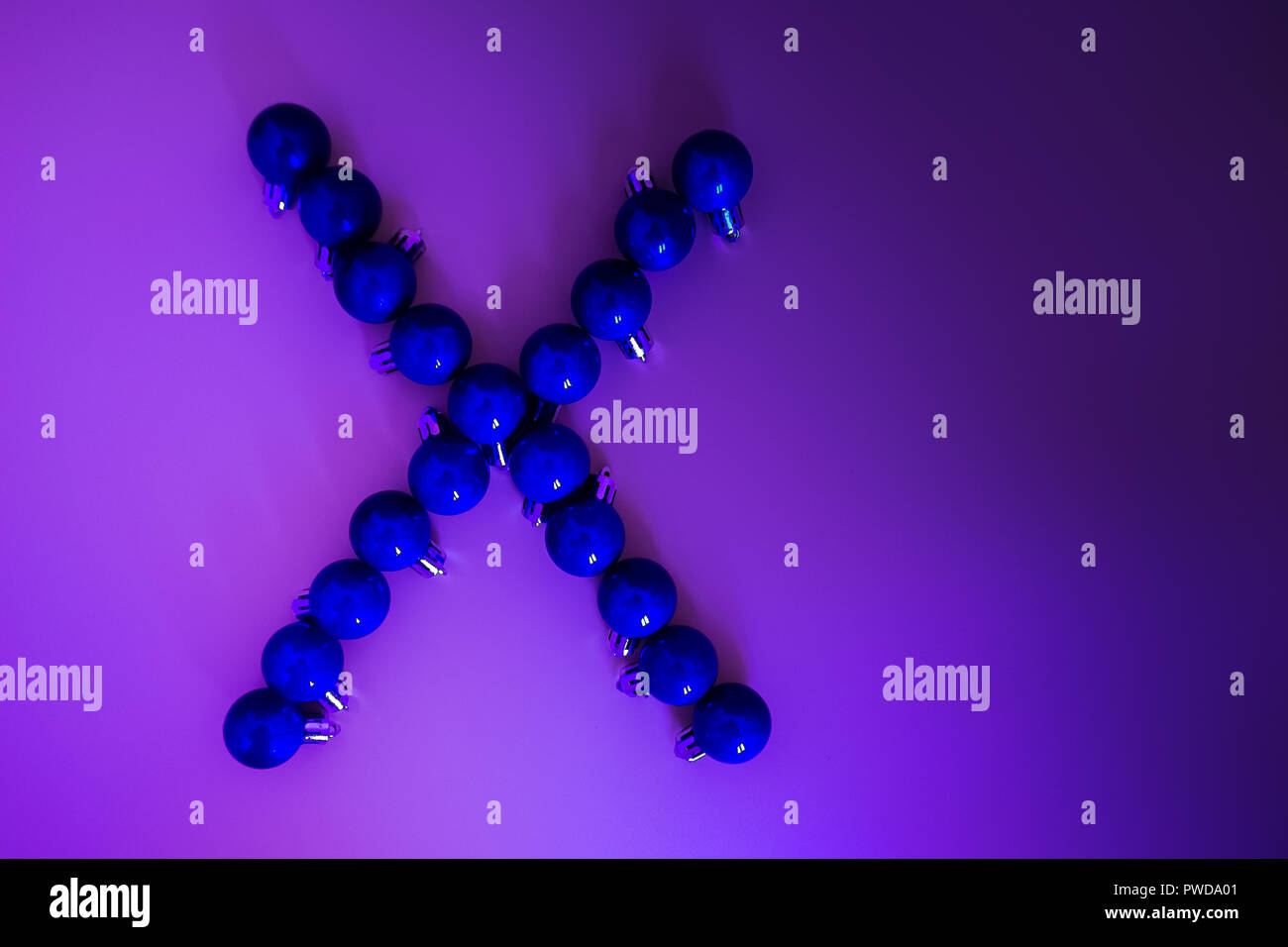 Christmas alphabet of blue neon Christmas balls on a gradient lilac ...