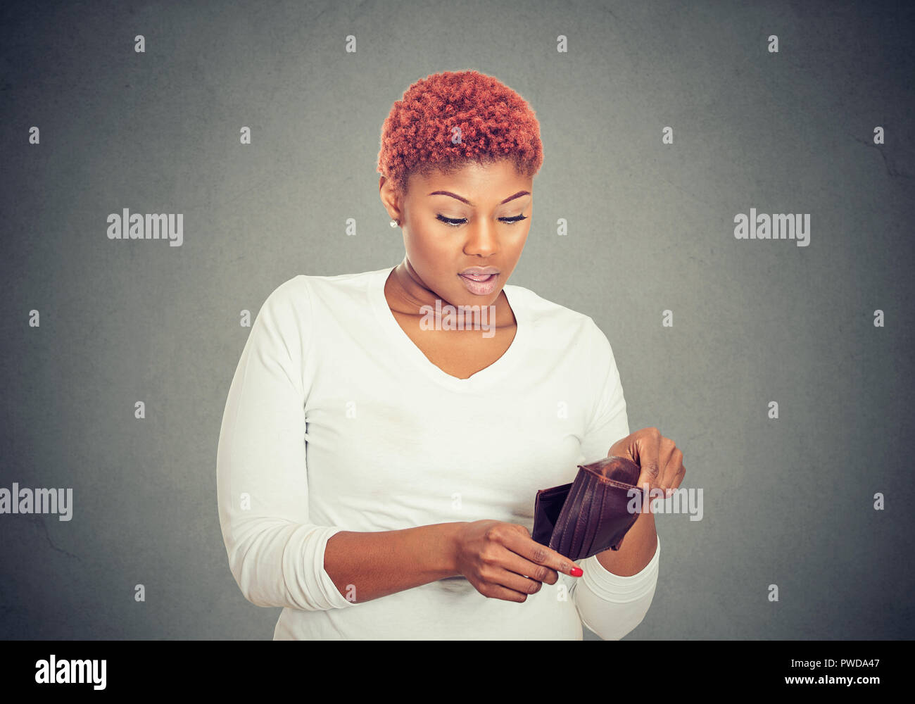 Sad poor young woman showing her empty wallet Stock Photo - Alamy