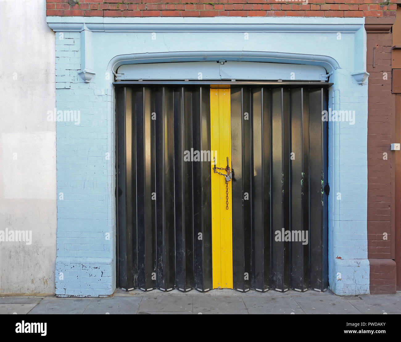 Closed Black Accordion Doors Locked With Padlock and Chain Stock Photo ...