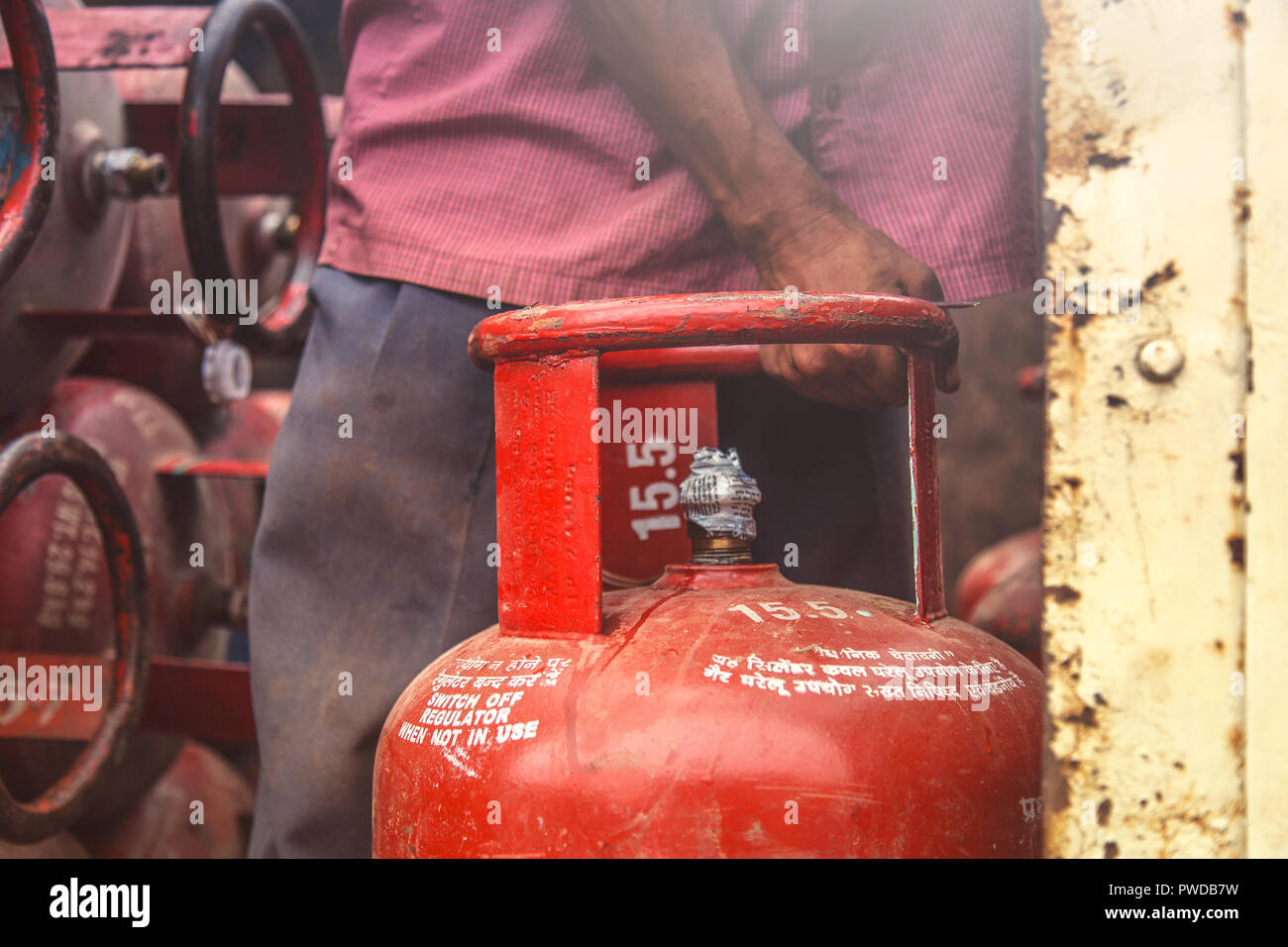 Worker delivering LPG gas cylinders into the truck for customers Stock ...