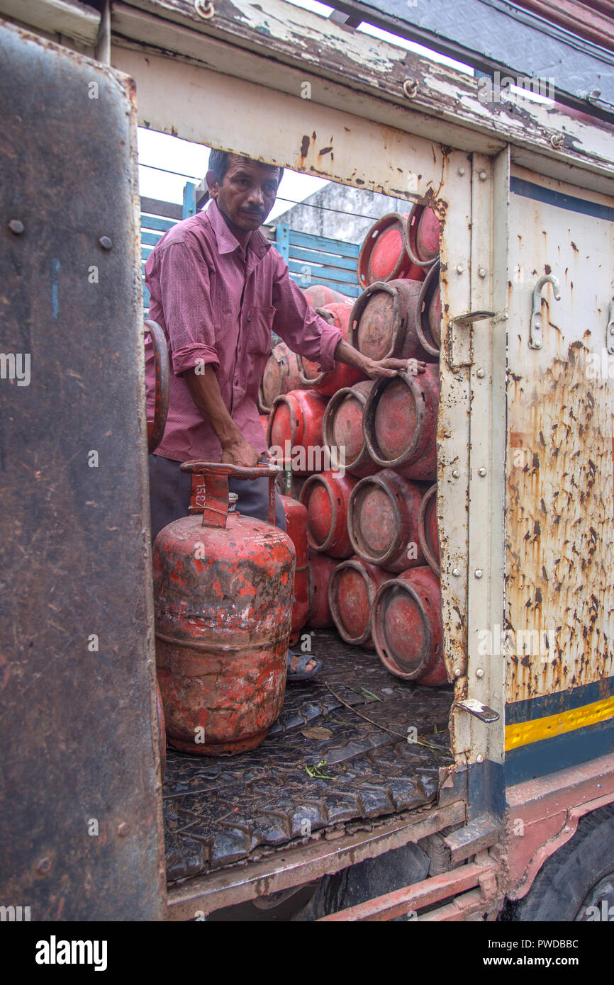 Worker delivering LPG gas cylinders into the truck for customers Stock ...