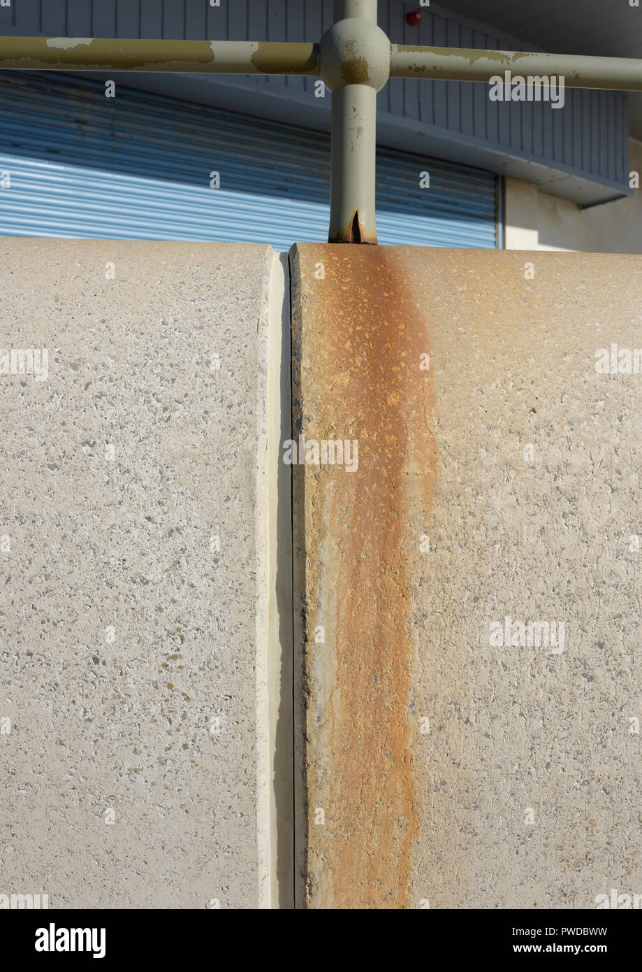 Rust stain on concrete, flexible expansion joint on sea wall and ...