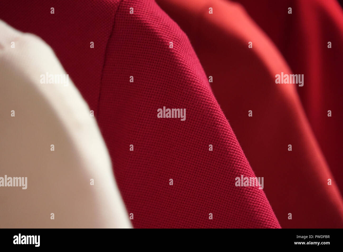 different colors polo shirt on display stand Stock Photo - Alamy